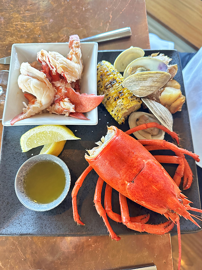 Maine's iconic crustacean takes center stage in this seafood symphony – bright red armor protecting sweet meat just waiting for its butter bath.