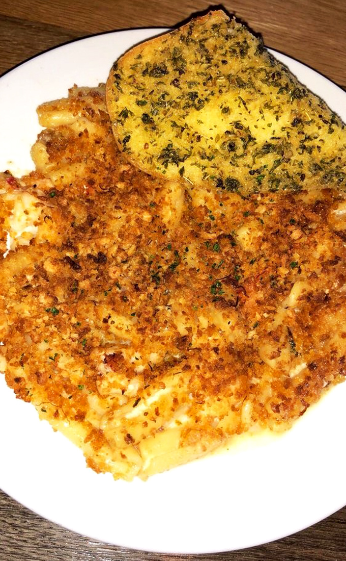 The contrast between the crispy breadcrumb topping and creamy cheese sauce makes each bite of this legendary dish a textural adventure worth savoring.