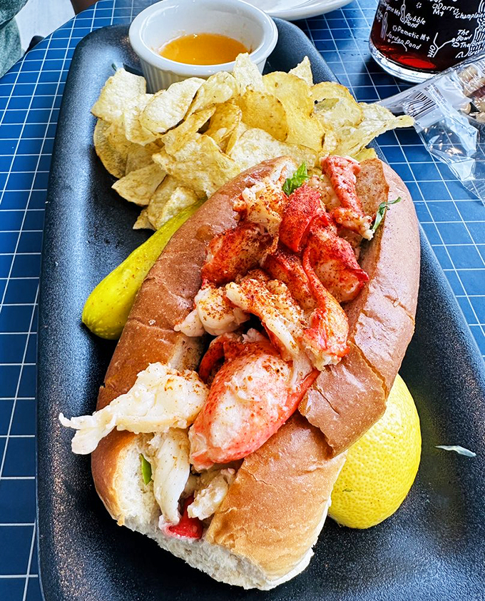 Holy crustacean! This lobster roll is so packed, it's like the seafood equivalent of clowns piling out of a tiny car.