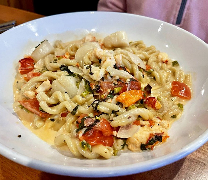 A pasta dish that speaks fluent "comfort" &ndash; handmade noodles swimming with fresh seafood and bright tomatoes.
