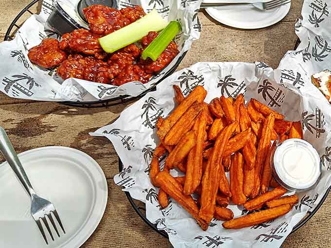Buffalo wings meet their perfect match in crispy sweet potato fries, creating a flavor combination that'll haunt your dreams in the best way.