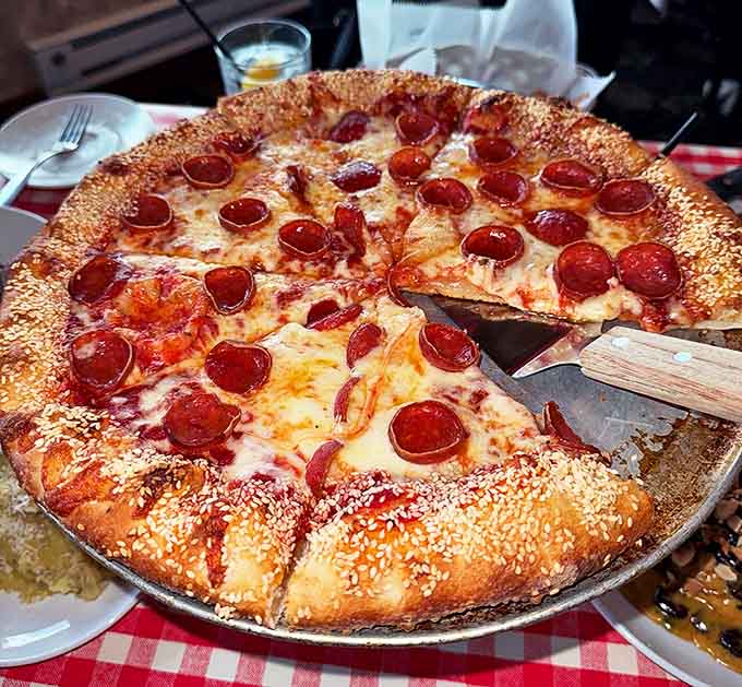 Pizza perfection achieved! That sesame seed crust cradles melty cheese and crisp pepperoni in a harmonious balance that chain restaurants can only dream about.