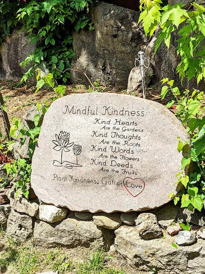 Plant Kindness, Gather Love &ndash; simple wisdom etched in stone invites visitors to carry the Temple's message beyond its physical boundaries.