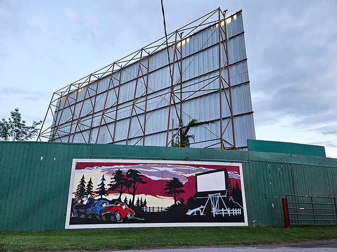 The colorful mural captures the nostalgic spirit of drive-in culture, a painted promise of the magic waiting beyond the entrance.