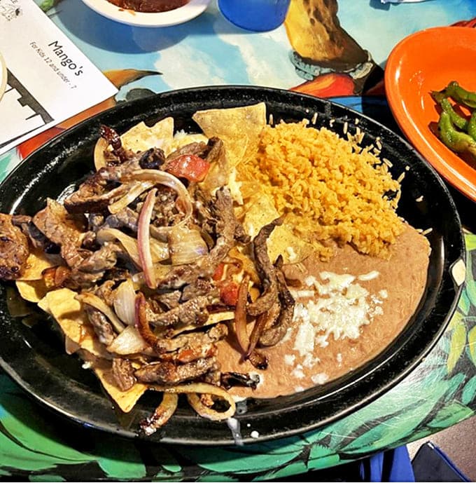 Nacho Fajitas: Sizzling steak strips nestled among crispy chips, melted cheese, and refried beans &ndash; proof that nachos can indeed be a complete meal.