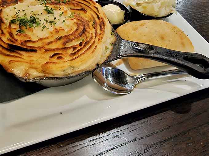 That golden crust on the champ potatoes gives way to savory filling below, comfort food achieving its highest calling here.