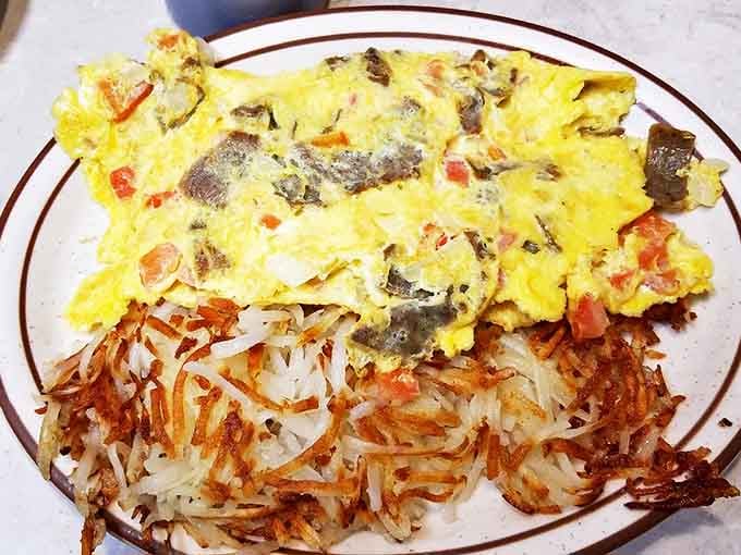 A perfectly executed Western omelet alongside crispy hash browns &ndash; the breakfast of champions and early risers alike.