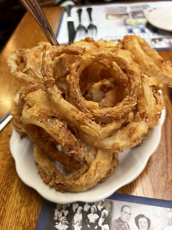 Golden, crispy onion rings stacked high&mdash;these aren't mere appetizers but edible architecture that would make structural engineers proud.