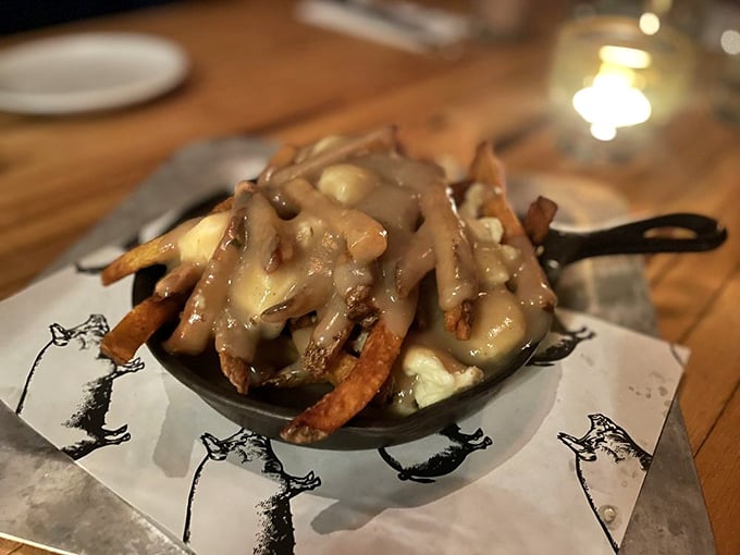 Poutine perfection: duck fat fries smothered in gravy and cheese curds create a dish that's worth every delicious, messy bite.