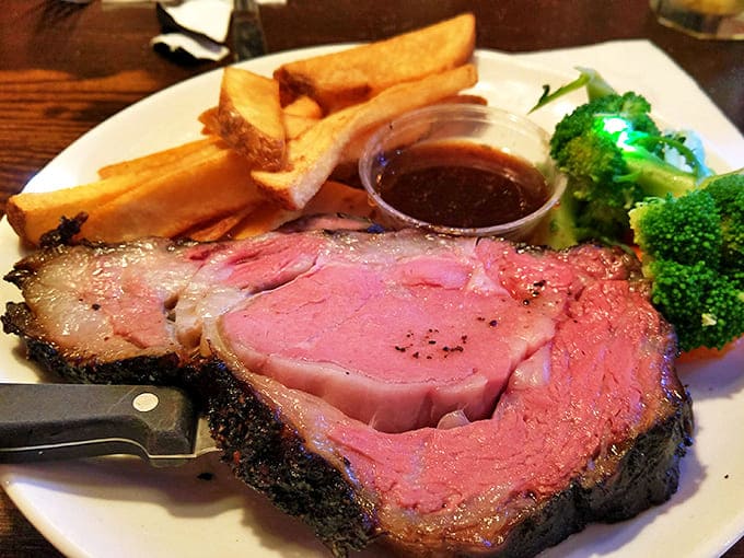 The prime rib arrives like royalty, accompanied by crisp broccoli and hand-cut fries that deserve their own fan club.