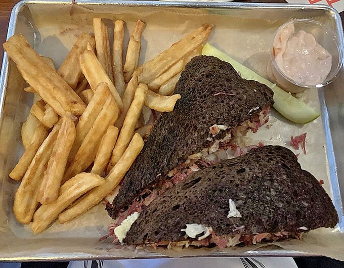 That towering Reuben on dark rye with crispy fries represents sandwich perfection that'll haunt your dreams in the best possible way.