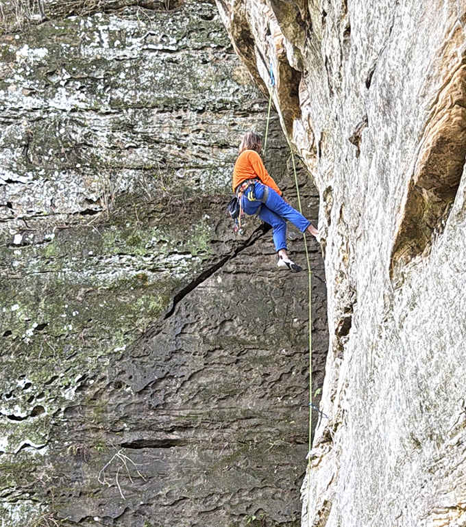 Suspended between earth and sky, this climber turns vertical sandstone into a natural playground. Talk about hanging out in style!