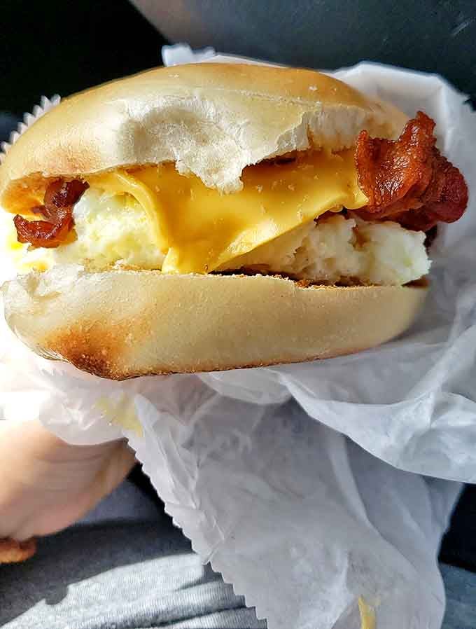 Melty cheese cascades over perfectly cooked eggs and bacon &ndash; a breakfast symphony in every bite.