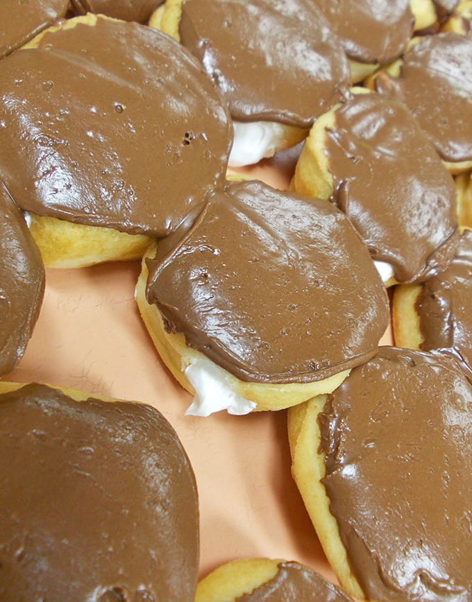 Those chocolate-covered beauties glisten under the lights, their glossy coating promising the kind of satisfaction that makes calories completely irrelevant.