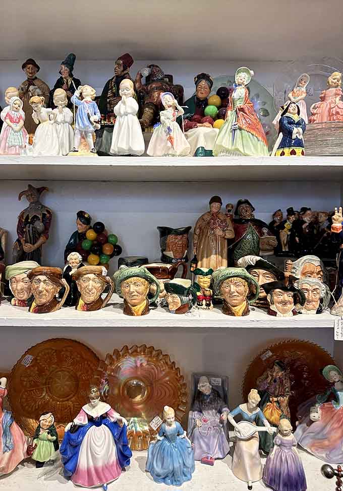 Royal Doulton character jugs and ceramic figurines line the shelves like a very distinguished, very British family reunion photo.