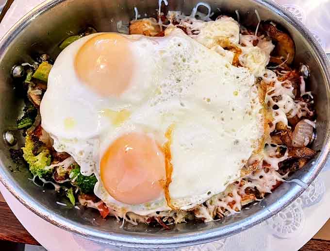 Skillet: A sizzling symphony of textures and flavors topped with perfectly runny eggs &ndash; breakfast architecture that would make Frank Lloyd Wright jealous.