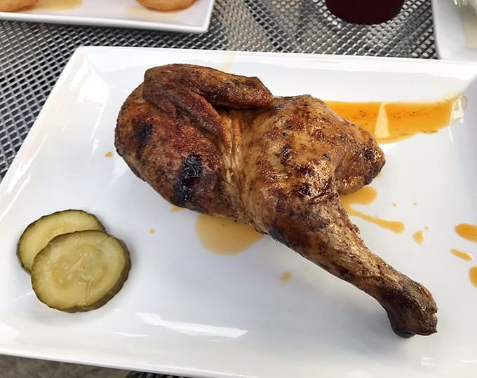 That perfectly smoked chicken leg glistens with promise, cooked to the kind of perfection that makes vegetarians question their life choices.