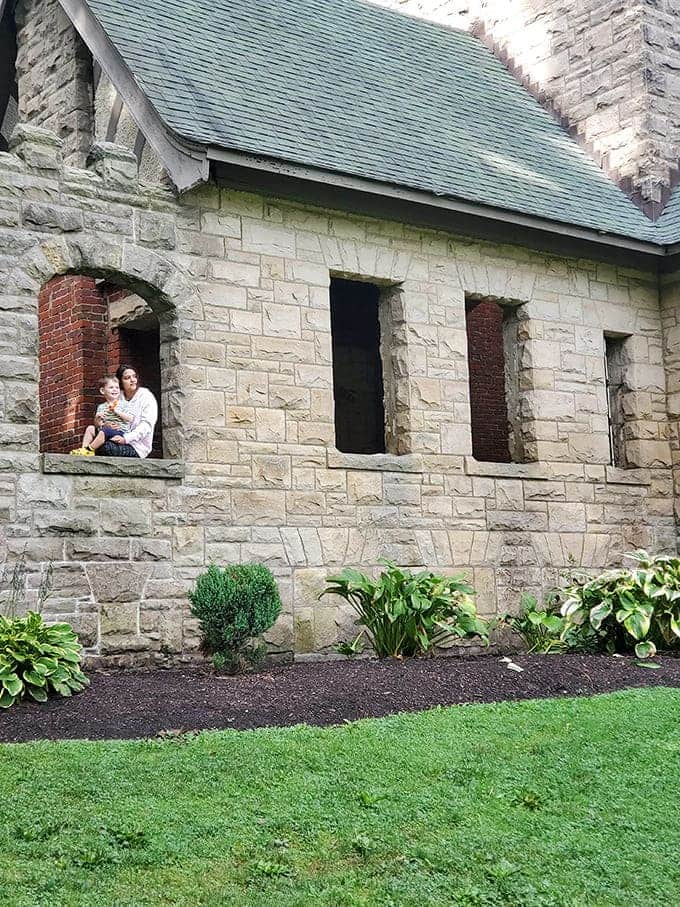 Nothing says "family bonding" quite like posing in the window of a potentially haunted castle on a random Tuesday afternoon.
