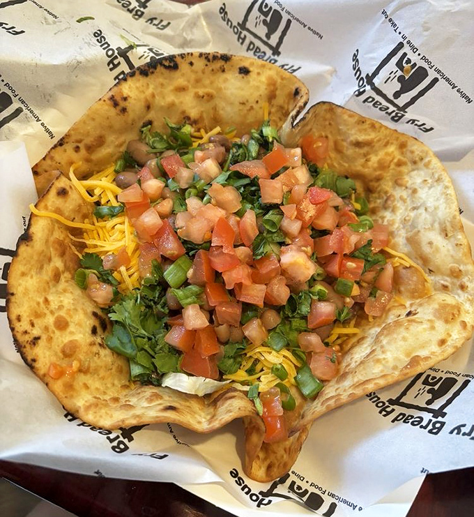 A taco salad that redefines the genre &ndash; crispy fry bread shell filled with fresh ingredients and topped with diced tomatoes. 