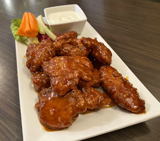 Sweet chili wings arrive glistening and gorgeous, proving that sticky and crispy can absolutely coexist on the same plate.