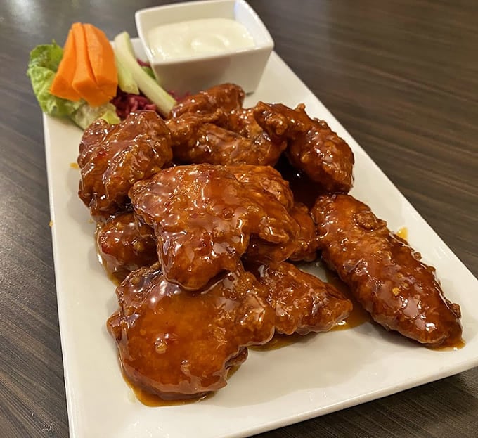 These boneless wings glisten with sauce, proving that sometimes the simplest pleasures are the most satisfying ones.
