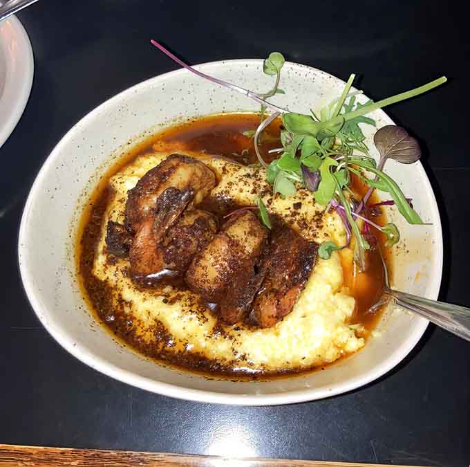 That bourbon butter and mysterious sauce turn good grits into the kind of dish you'll dream about later.