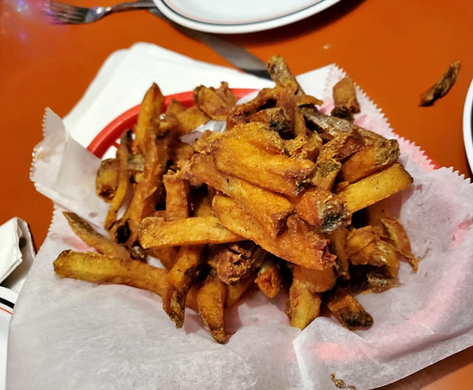 Sweet potato fries with skins still on, fried to crispy perfection and seasoned like they're auditioning for a cooking show.