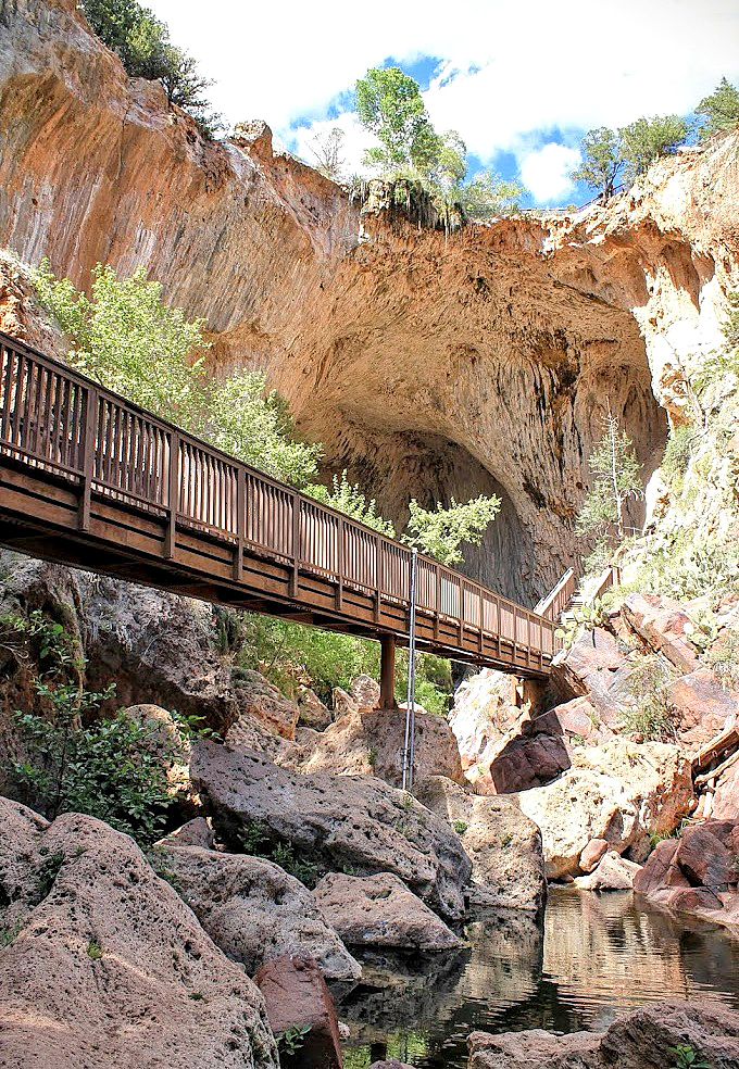 Engineering meets nature as the viewing platform nestles beneath the travertine giant, offering humans a safe perch to contemplate geological time.