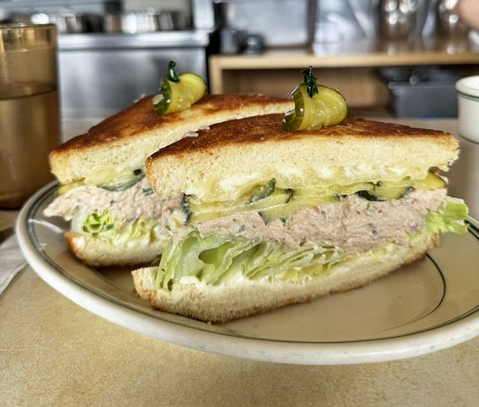 This isn't your sad office lunch tuna sandwich – it's a griddled monument to what happens when simple ingredients meet extraordinary technique.