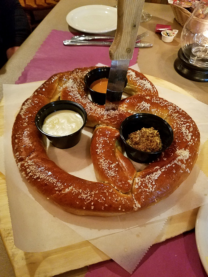 The giant pretzel arrives like an edible work of art, dusted with salt and accompanied by dipping sauces that elevate bread to an experience.
