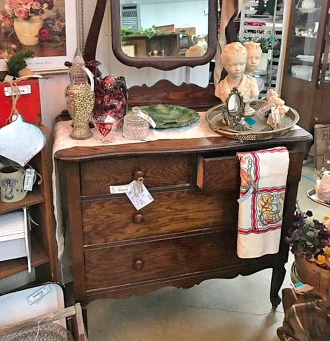 That dresser has witnessed more family secrets than a therapist. Its worn wood and elegant lines speak of quality that's outlasted generations of trends.