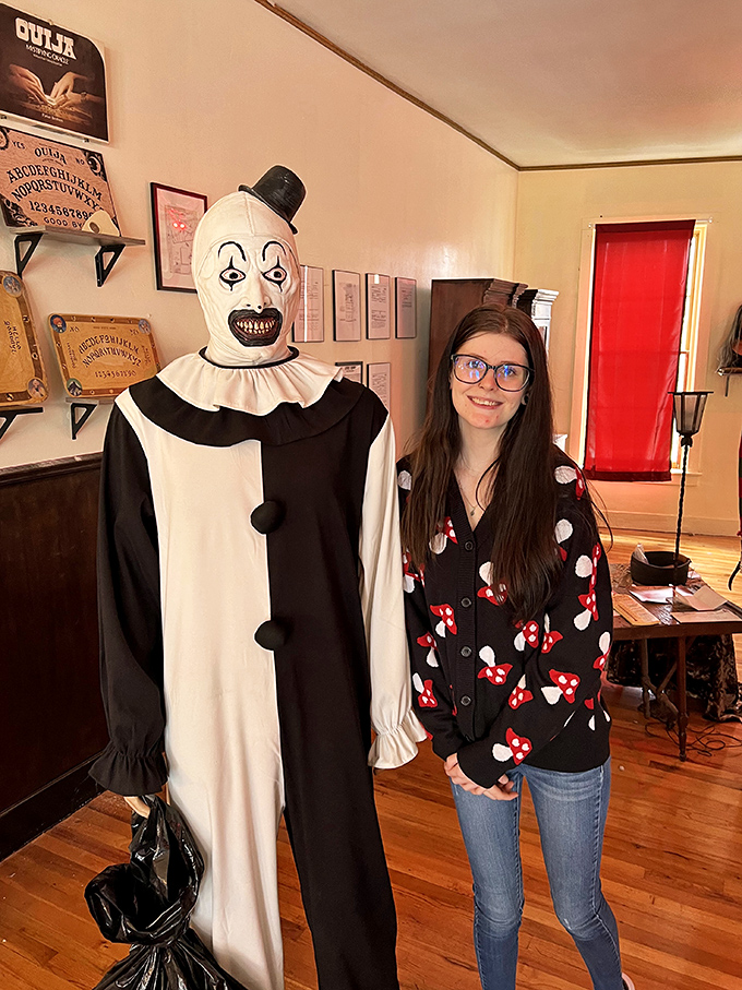 A terrifying clown figure stands ready to greet visitors, its fixed smile hiding untold horrors behind those painted eyes.