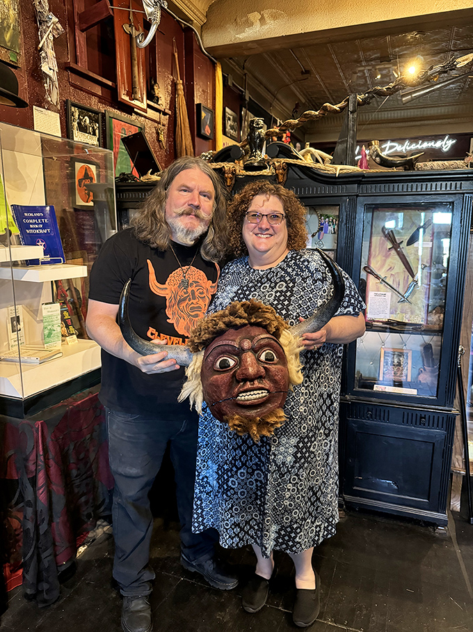 The museum's displays provide the perfect backdrop for visitors holding unusual artifacts. That wooden mask looks like it has stories to tell!