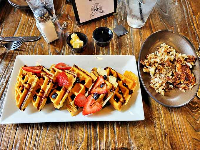 Golden waffles with fresh strawberries alongside perfectly crispy hashbrowns &ndash; breakfast doesn't get more picture-perfect than this morning masterpiece.