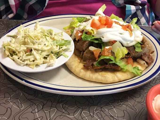 That gyro sandwich with coleslaw is what food dreams are made of, piled high with perfectly seasoned meat and fresh vegetables.