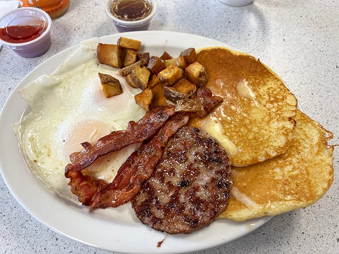 The holy trinity of breakfast bliss &ndash; perfectly cooked eggs, crispy bacon, and pancakes that make you question why you'd eat anything else.