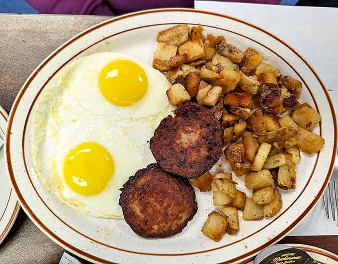 Two sunny eggs gaze up at you while those sausage patties and crispy potatoes complete this morning masterpiece.