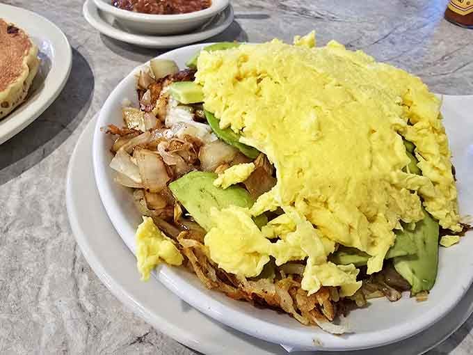 Breakfast architecture at its finest &ndash; fluffy eggs crowning a foundation of potatoes and sausage gravy that would make any morning better.