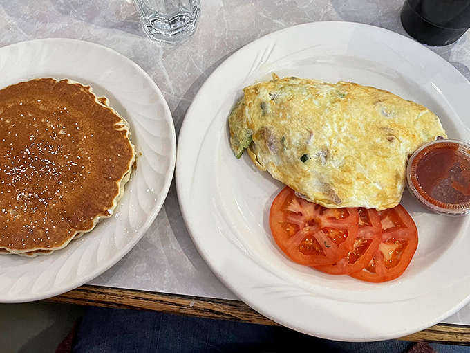 A proper breakfast spread that includes pancakes and an omelet, because sometimes you need to hedge your bets on deliciousness.