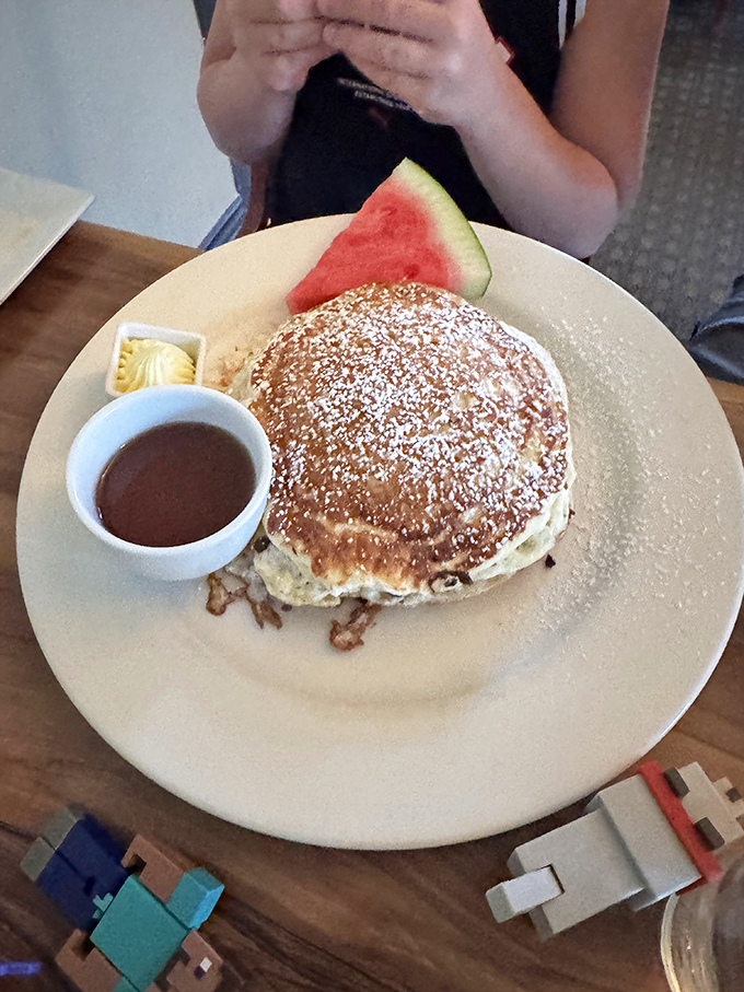 Pancakes so fluffy they could double as pillows, dusted with powdered sugar like fresh Vermont snow.