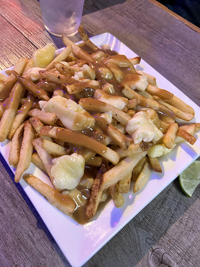Poutine perfection! Hand-cut fries smothered in gravy and cheese curds create a Canadian-inspired dish that's worth crossing borders for.