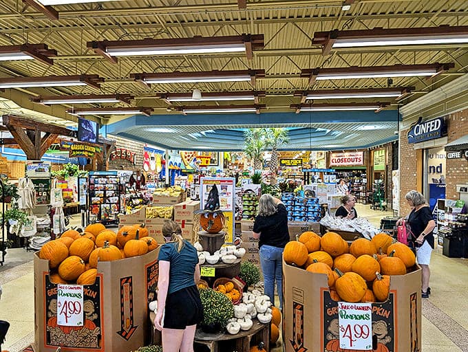 Shoppers browse seasonal offerings in a space that feels more like a farmers market fever dream than a typical grocery store aisle.