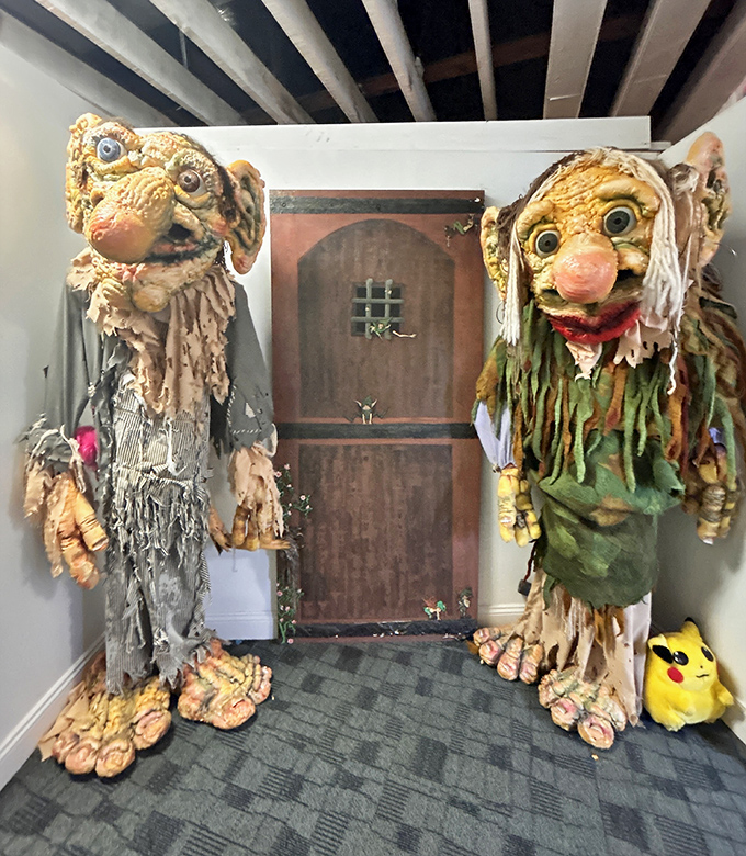 These life-sized troll guardians flank the doorway like sentinels from a fever dream you didn't know you had.