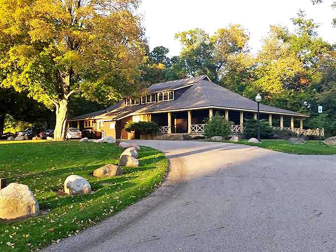 The rustic lodge welcomes visitors with its wraparound porch, promising shelter and stories beneath its weathered wooden beams.