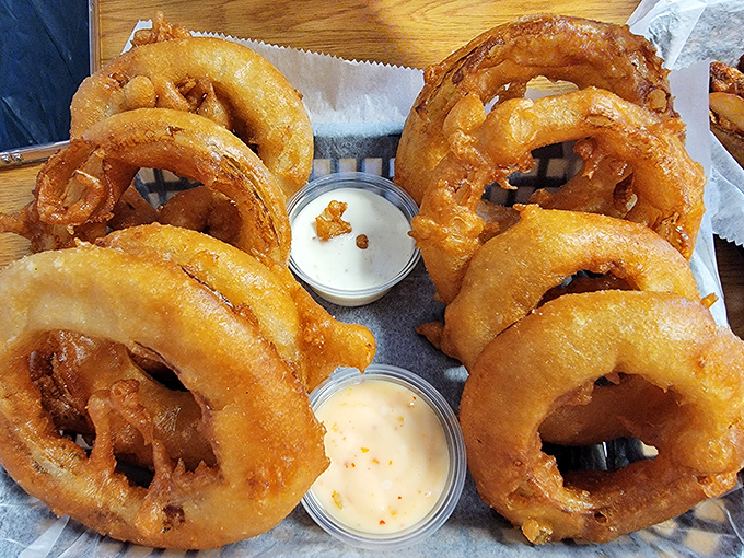 Golden-brown onion rings that shatter with each bite, served with dipping sauces that'll make you forget ketchup exists.