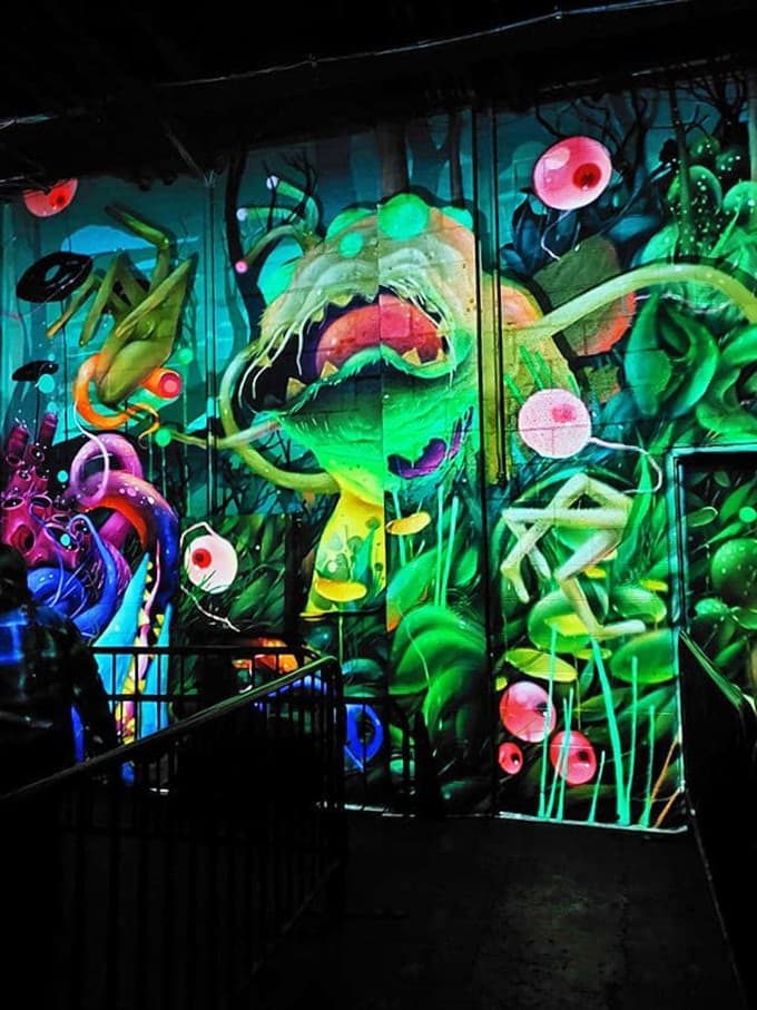 This psychedelic nightmare wall makes you wonder if the artists were inspired by horror films or just really questionable mushrooms.