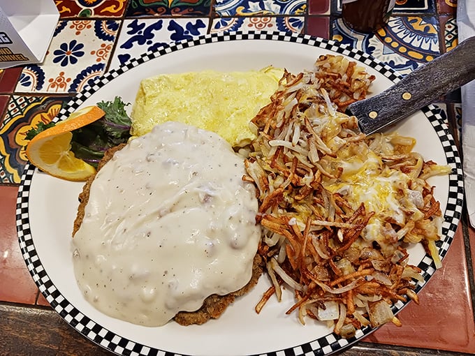 A masterclass in comfort food execution &ndash; the chicken fried steak comes smothered in velvety gravy alongside crispy hash browns and eggs cooked just right.