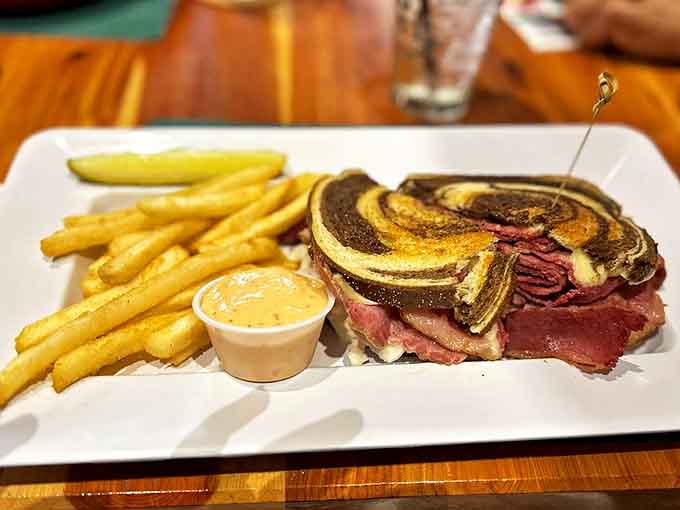 Golden French fries accompany the star attraction, providing the perfect crispy companion to that magnificent Reuben that's earned its legendary status among sandwich aficionados.