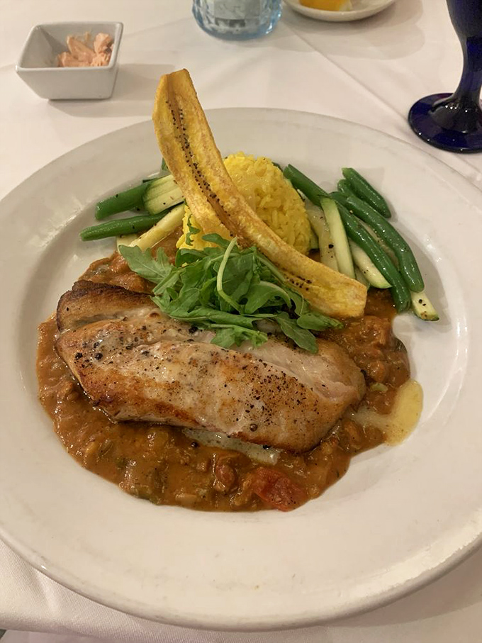 Local snapper gets the royal treatment, served with seasonal vegetables and a plantain that adds just the right tropical touch.