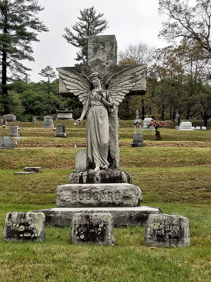 The Hubbard monument's stone angel stands eternal watch, her weathered wings and solemn expression capturing Victorian-era grief in permanent form.